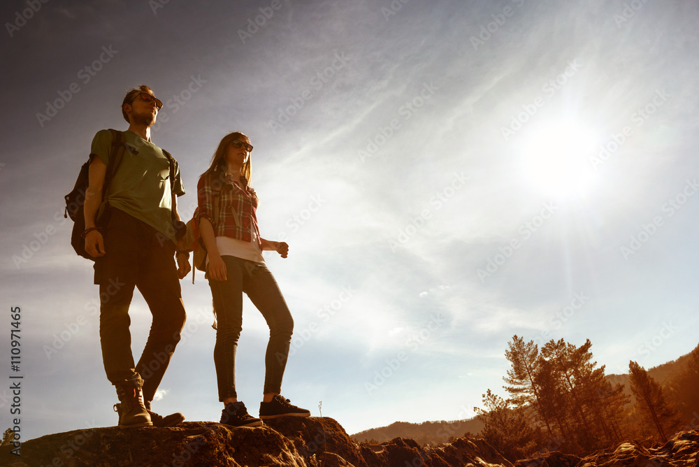 Couple of backpackers on sky backdrop Stock Photo | Adobe Stock