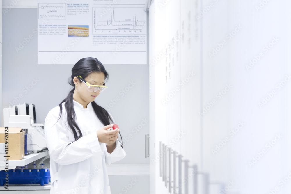 Female scientist reading specimen label in laboratory Stock Photo ...