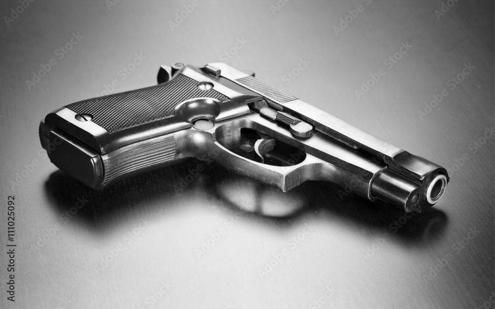 Gun on desk Stock-Foto | Adobe Stock