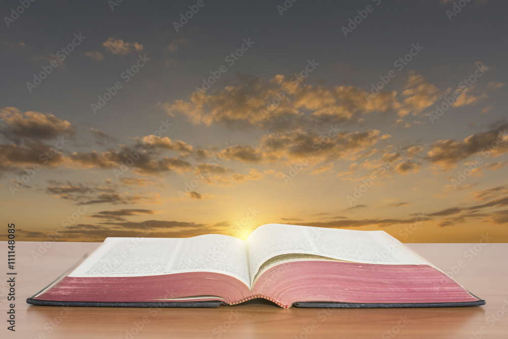 open bible with sunset sky background Stock Photo | Adobe Stock