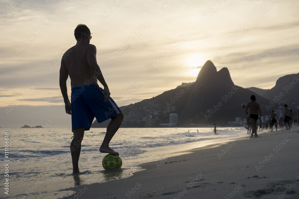 Brazil, Rio De Janeiro, man standing with ball on Ipanema beach Stock ...