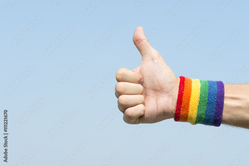 Hand of athlete giving thumbs up with gay pride rainbow colors ...