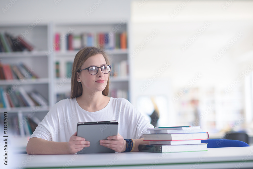 female student study in school library, using tablet Stock Photo ...
