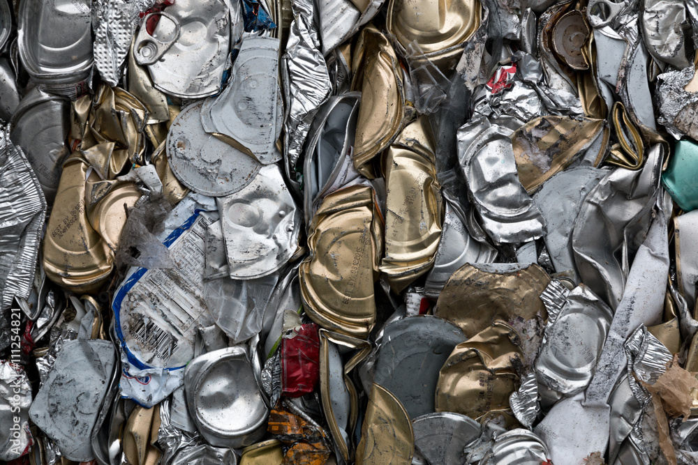 flattened cans at a recycling facility. Stock Photo | Adobe Stock