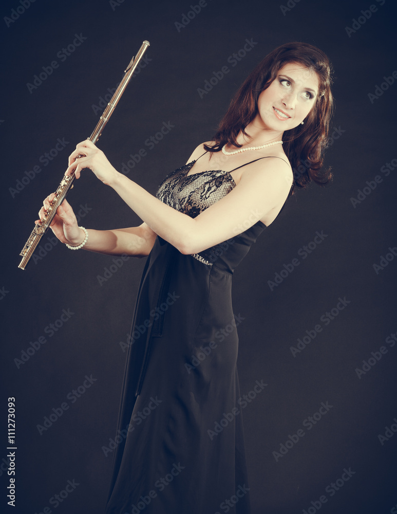 Elegant woman with flute instrument. Stock Photo | Adobe Stock