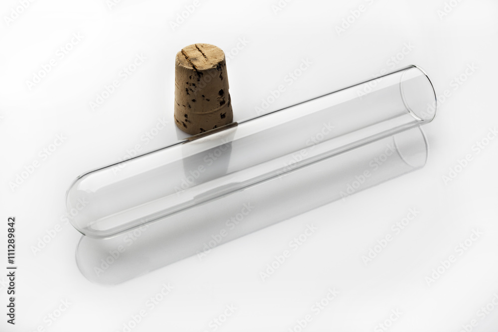 Glass transparent test tube with cork aside on white background ...