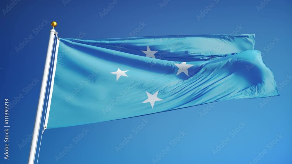 Federated States of Micronesia flag waving in slow motion against blue ...
