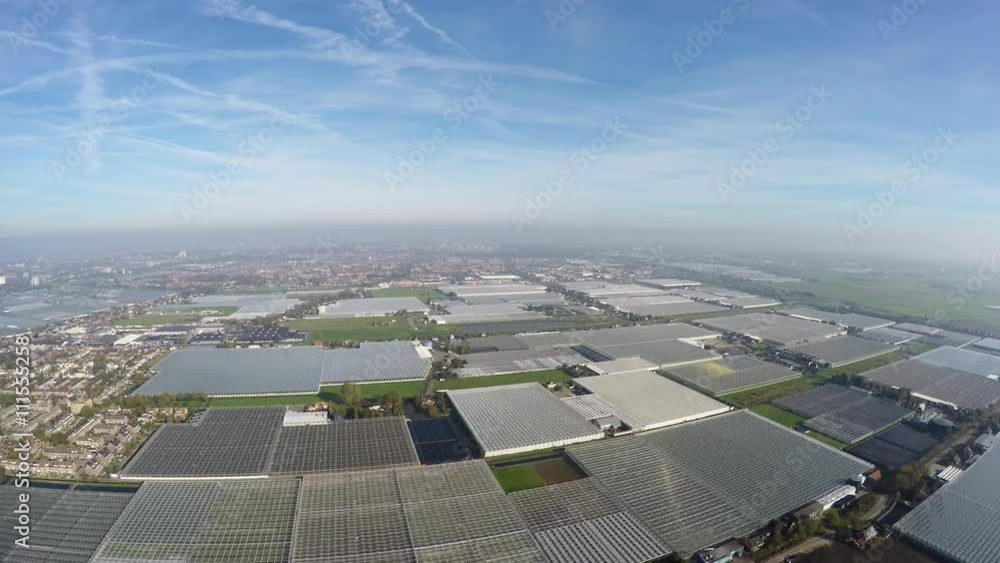 Aerial footage a large greenhouse glasshouse area showing an overview ...