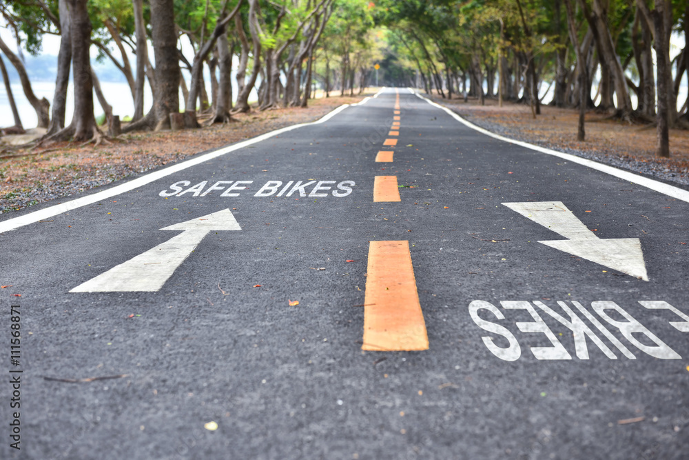 Safety concept, Safe bikes words with white arrow sign marking on road ...