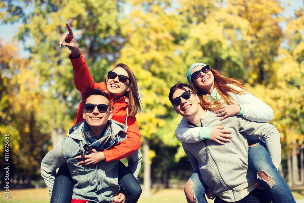 Fotografia do Stock: happy friends in shades having fun at autumn park ...