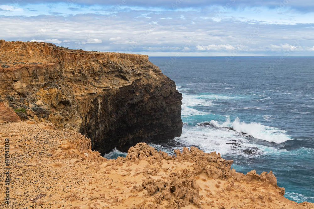 Landscape view of coastal cliff at Petrified Forest Walk with deep blue ...