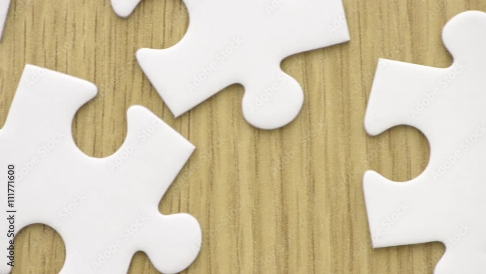 Blank white puzzle pieces as symbol of team work Stock Video | Adobe Stock