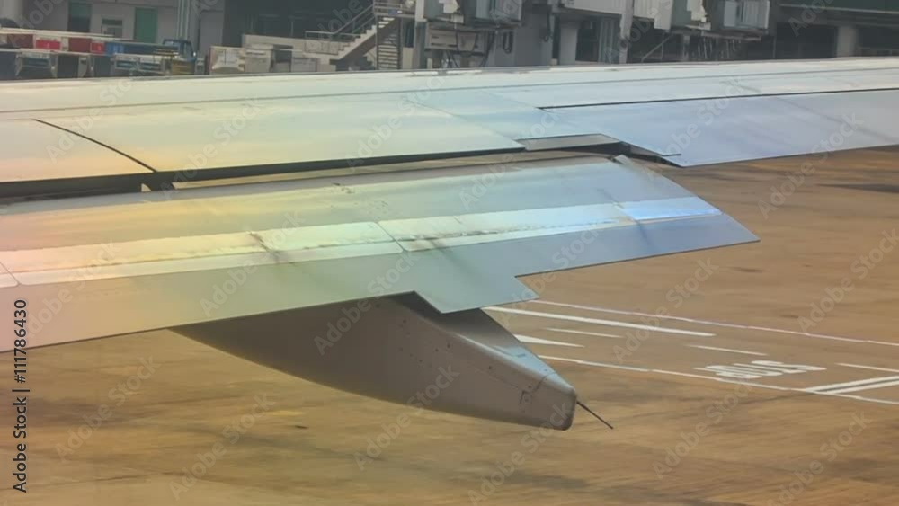 Passenger Loading Bridge behind Airliner Wing on Airfield Stock-video ...