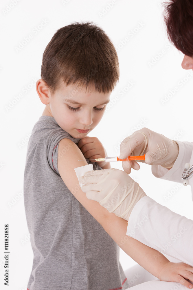 Doctor giving a child injection in arm on isolated image. Stock Photo ...