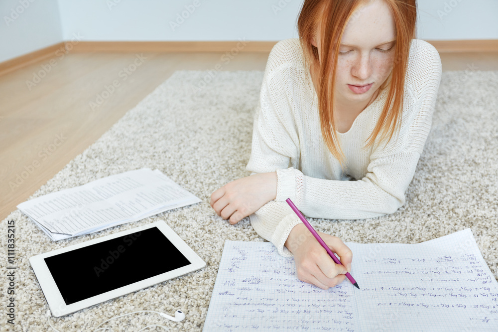 Fotografia do Stock: Portrait of redhead teenage girl writing a ...