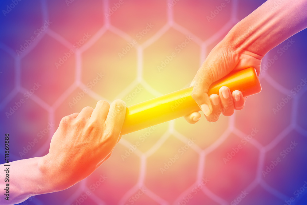 hands passing a relay baton on on soccer goal net background with ...