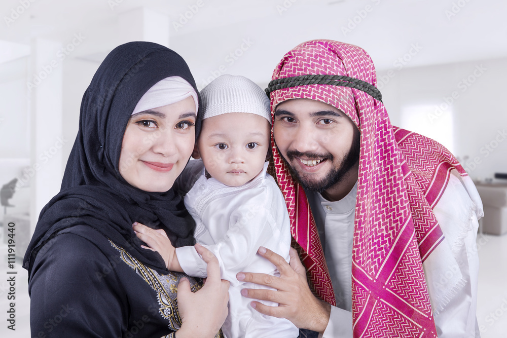 Happy Arabic parents and their child at home Stock Photo | Adobe Stock