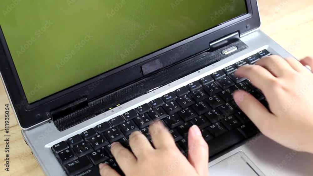 close-up types on laptop keyboard and touch-pad by female fat fingers ...