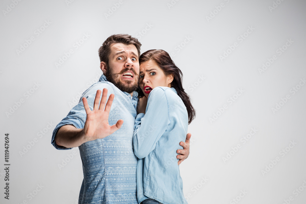 Emotional facial expression wide eyed couple, woman an man looking ...