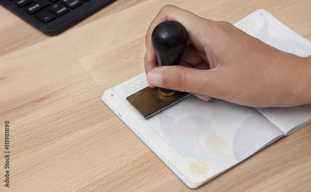 Immigration control officer will arrival stamp in the passport Stock ...