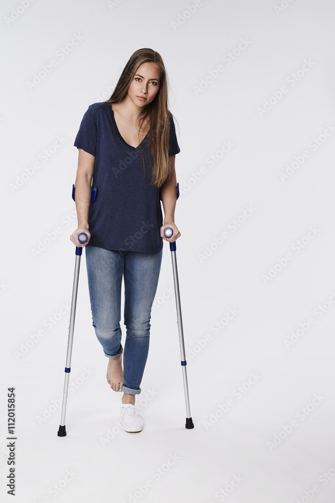 Beautiful woman on crutches, portrait Stock Photo | Adobe Stock