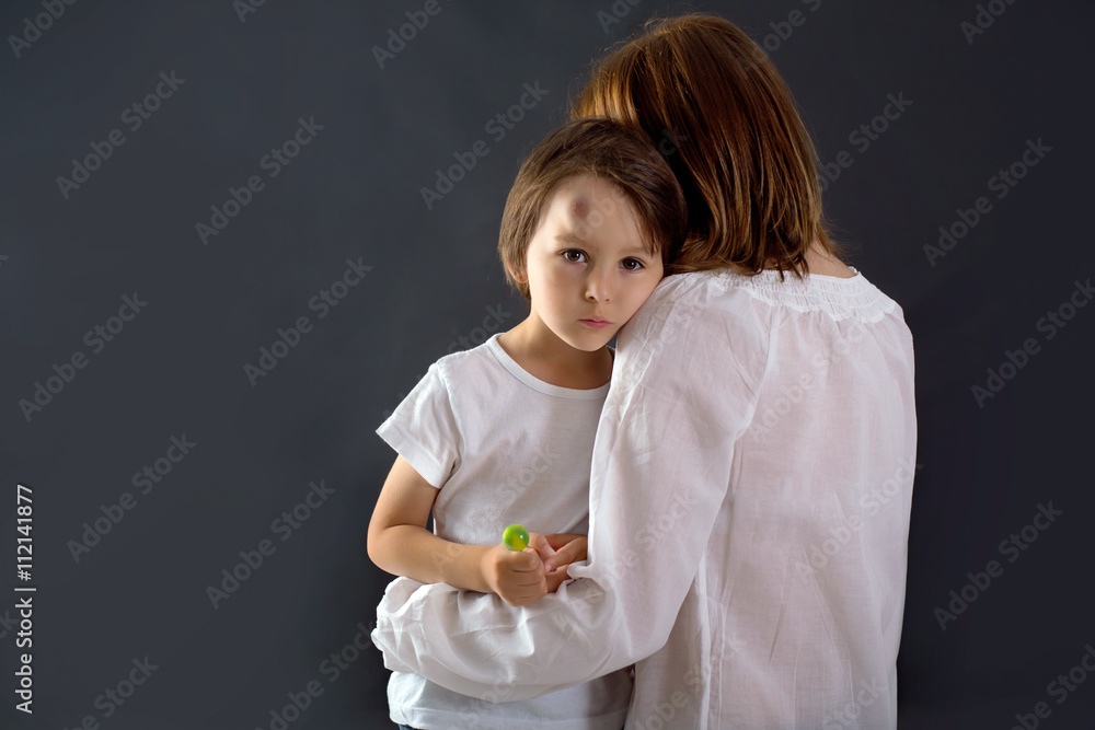 Cute little boy with big bump on his forehead from falling, hugg Stock ...
