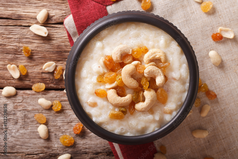 Indian kheer rice pudding with nuts and raisins close-up. horizontal ...