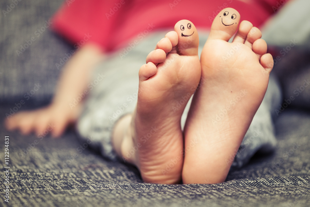 Kids feet with smiley faces drawings Stock Photo | Adobe Stock