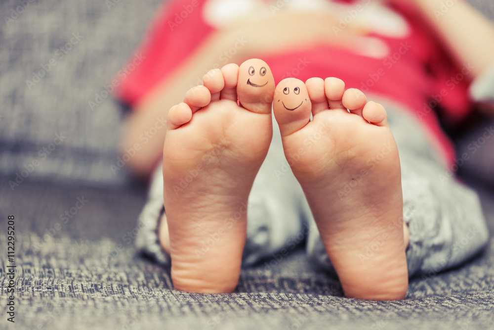 Kids feet with smiley faces drawings Stock Photo | Adobe Stock