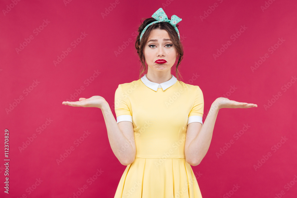 Sad pinup girl standing and holding copyspace on both palms Stock Photo ...