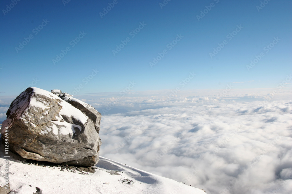 Poster A rock in the white snow, atop a sea of snow-white clouds, Jade ...