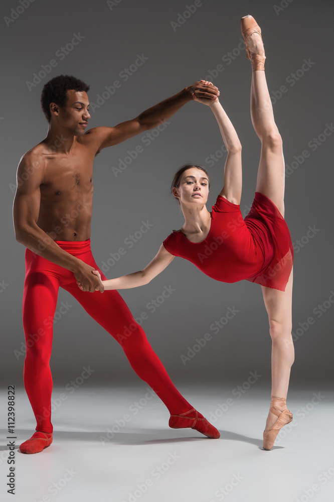 Couple of ballet dancers posing over gray background Stock Photo ...