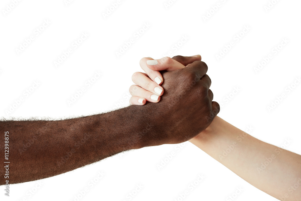 Arm wrestling against racism. Black and white human holding hands in a ...