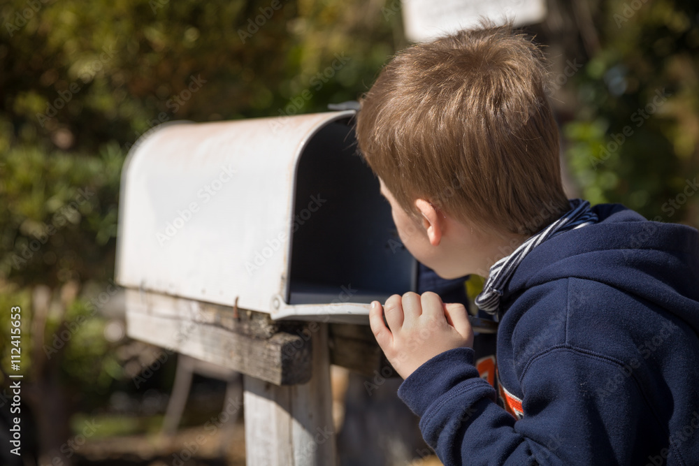 School boy opening a post box and checking mail. Kid waiting for a ...
