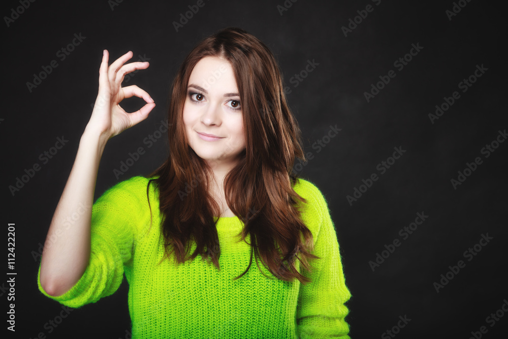 teen girl showing ok sign hand gesture on black Stock Photo | Adobe Stock