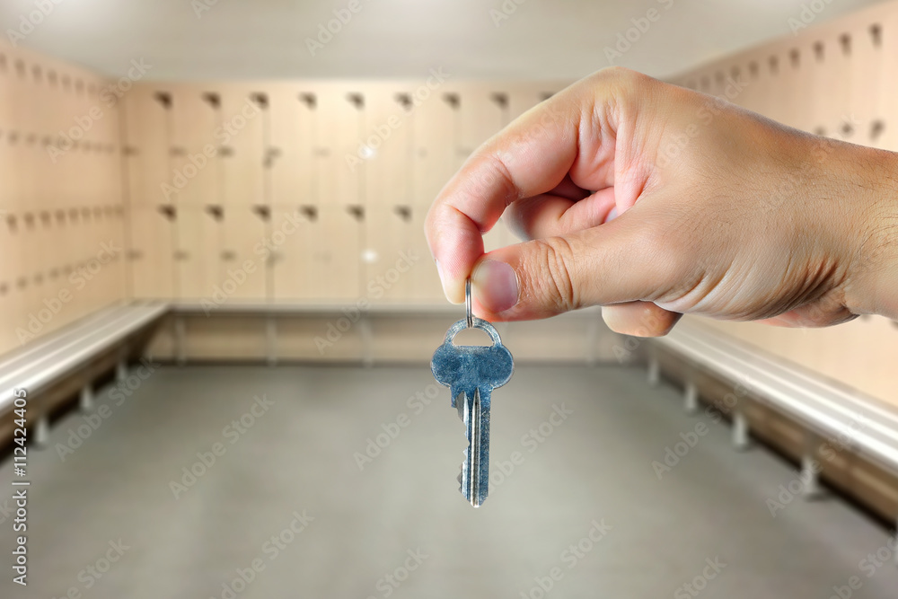 Hand Holding a Key in a Locker Room Stock Photo | Adobe Stock