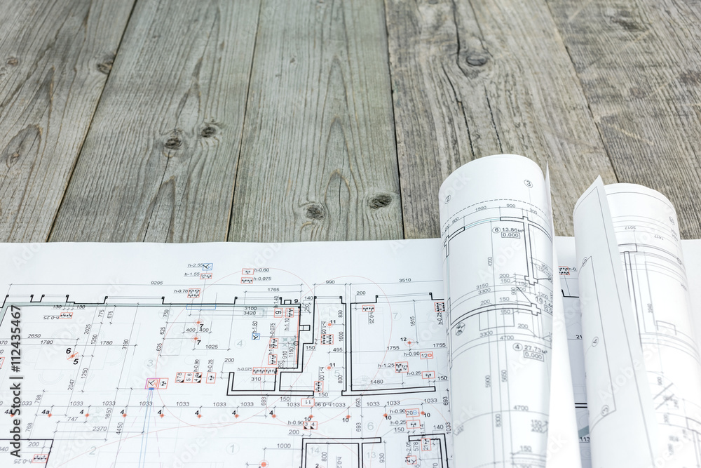 floor plan with rolls of architectural blueprints on wooden desk Stock ...