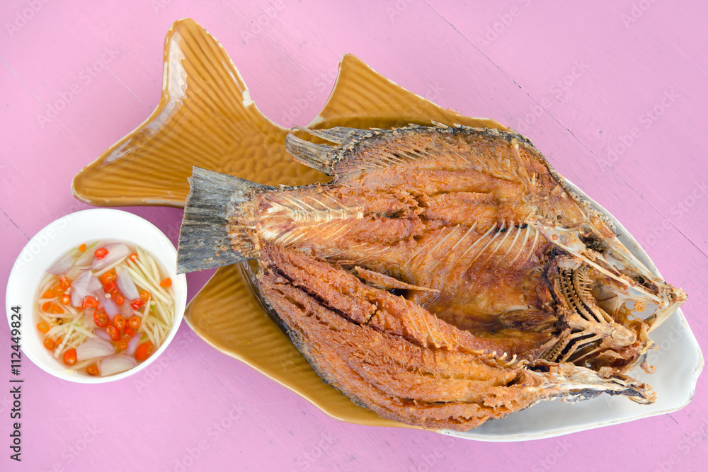 Fried striped bass fish with fish and oyster sauce Stock Photo | Adobe ...