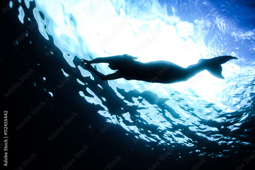 Mermaid silhouette floating in the ocean. Bottom view Stock Photo ...