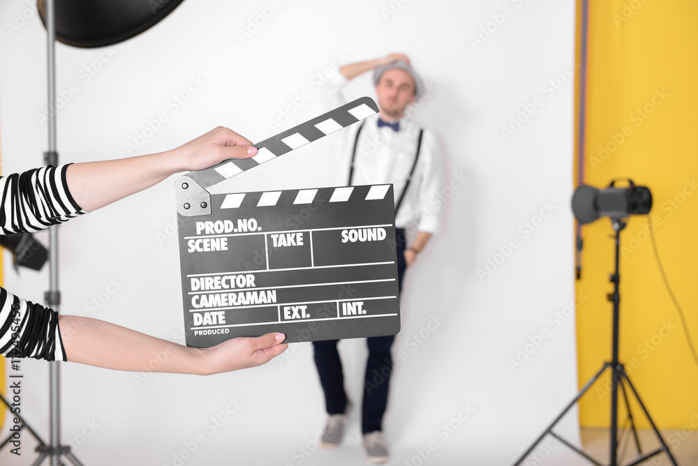 Movie clapper and young man on background in photo studio Stock Photo ...