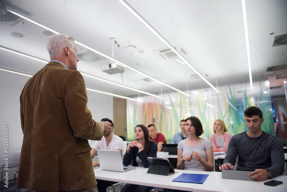 teacher with a group of students in classroom Stock Photo | Adobe Stock