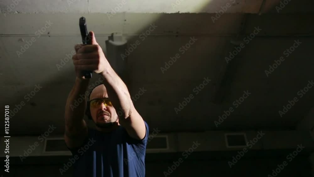 Man shooting a gun. man shoots at a shooting range Stock ビデオ | Adobe Stock