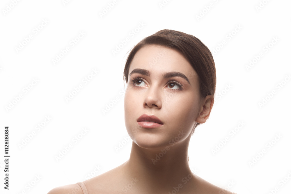 Closeup portrait of young woman's face looking away over white ...