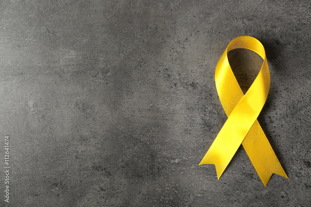 Yellow awareness ribbon on grey textured background Stock Photo | Adobe ...