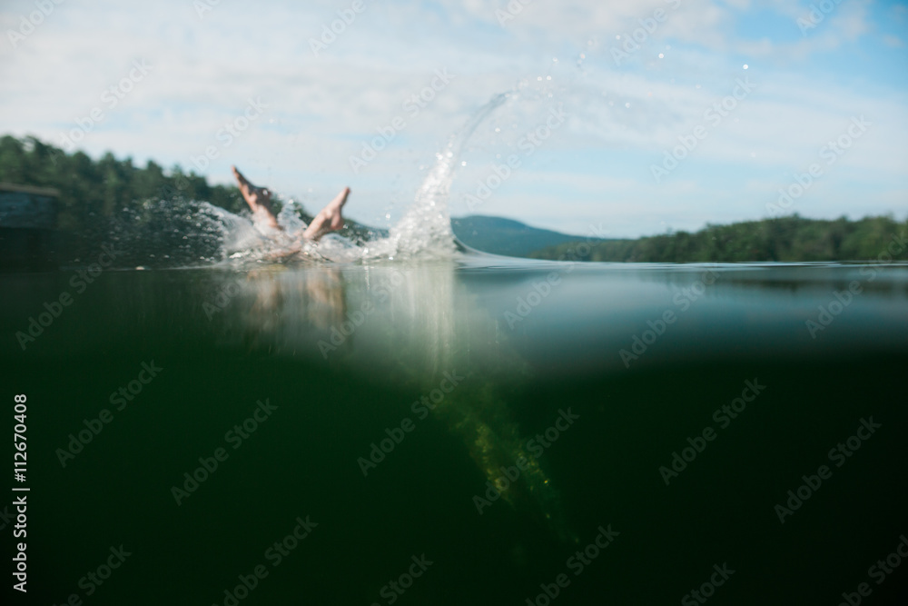 Boy diving into lake Stock Photo | Adobe Stock