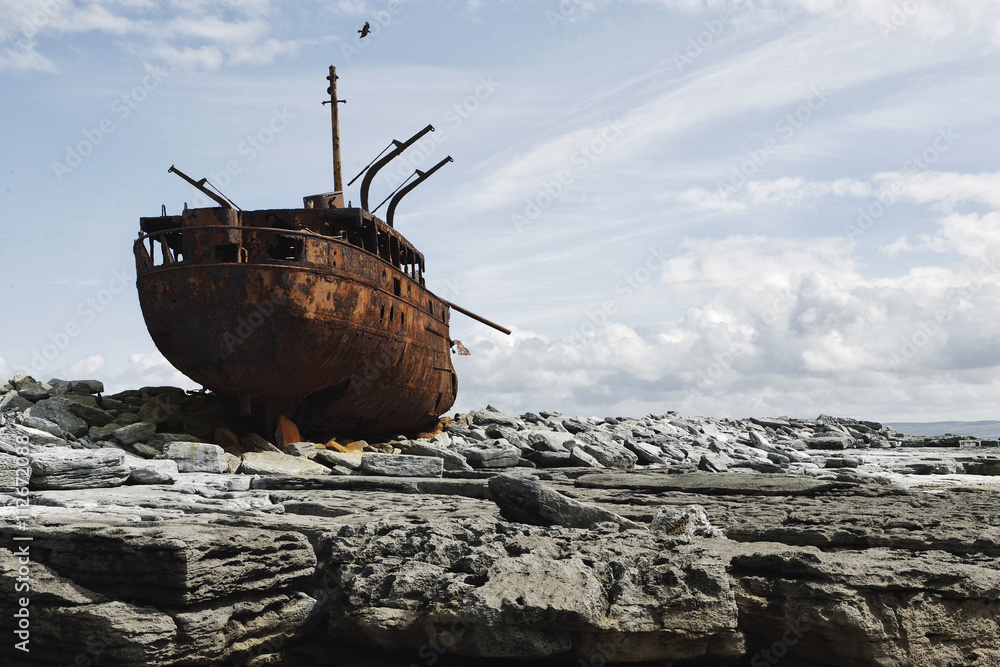 Rusted shipwreck on rocks Stock Photo | Adobe Stock