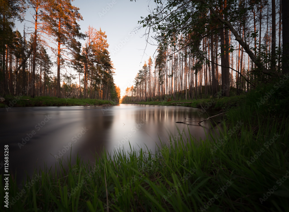 Natural river with surrounding trees photographed with long exposure ...