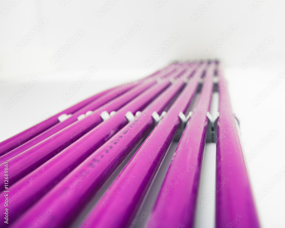 purple plastic pipes of underfloor heating system Stock Photo | Adobe Stock