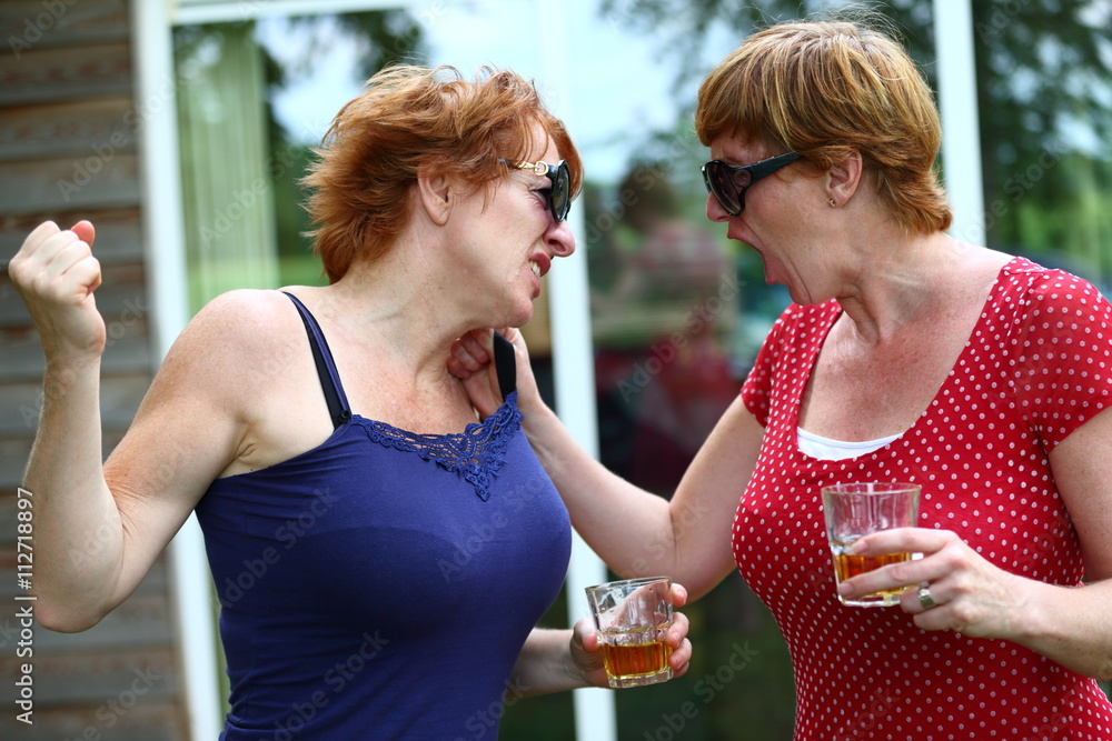 aggressive/ two women fighting under the influence of alcohol Stock ...