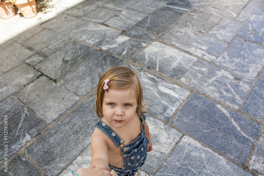 Follow me concept. Cute little girl pulling mom's hand - hand in hand ...